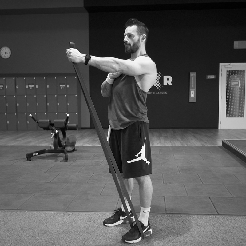 Elévation frontale du bras avec un élastique, debout - Nolan Coach Sportif